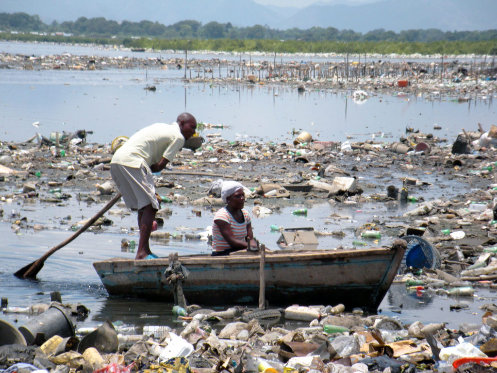Photo providedA Haitian couple pushes through garbage in Cap-Haitien ...